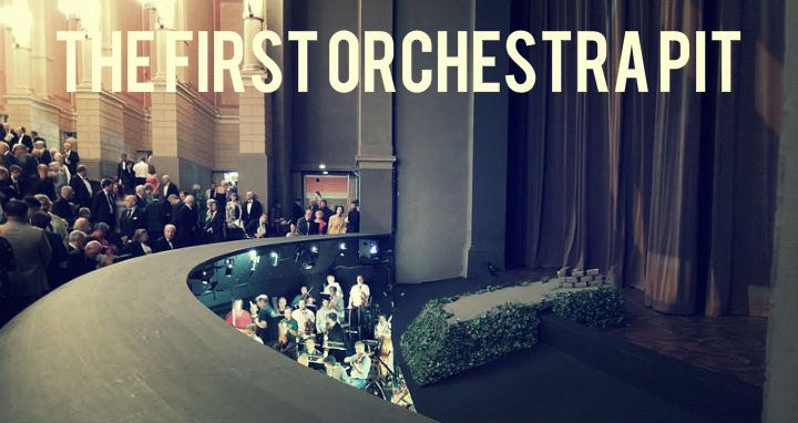 WHEN WAS THE ORCHESTRA PIT FIRST INVENTED?